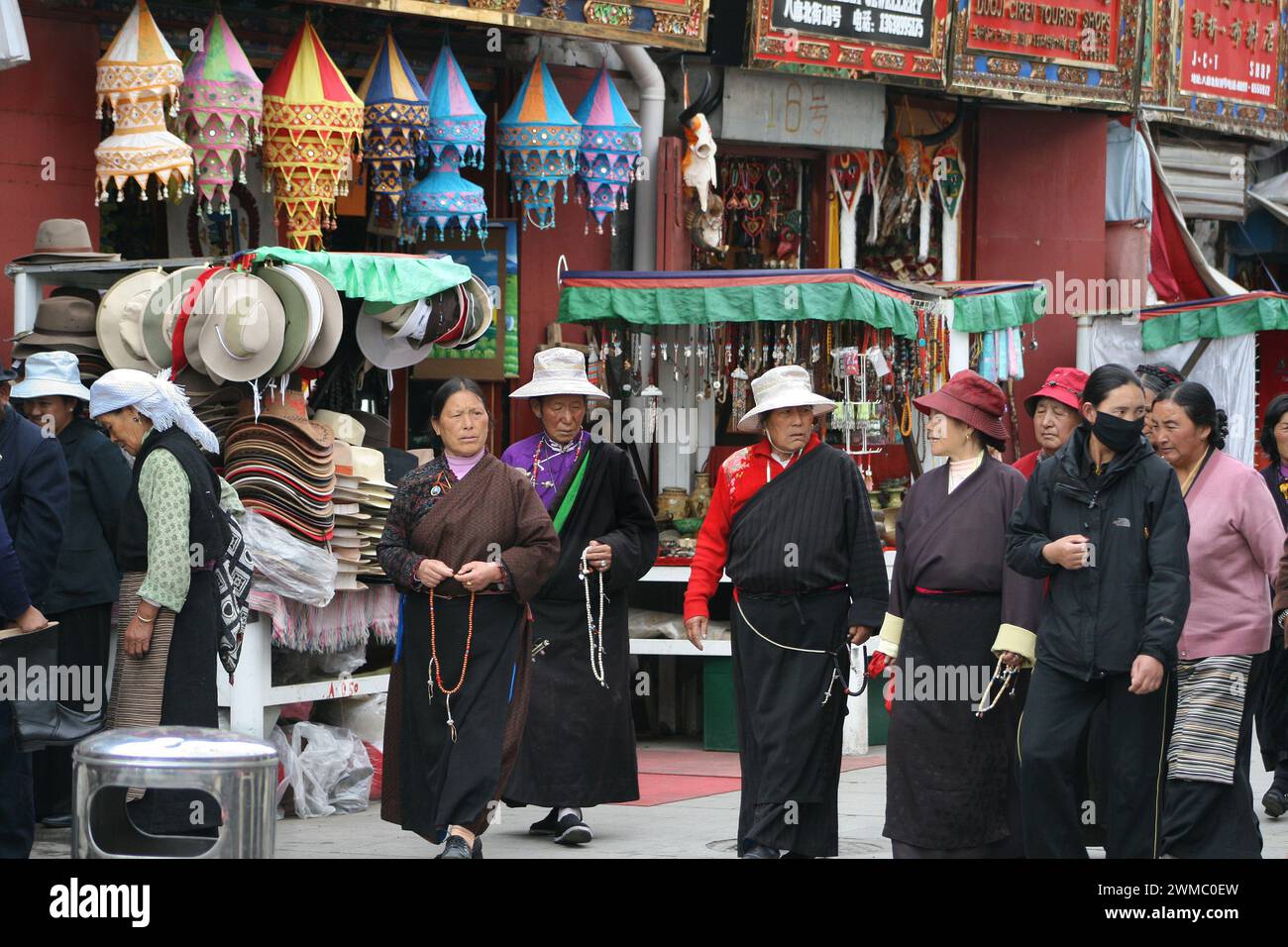 Jokhang Lhasa Tibet outdoor market with traditional dress and hats ...