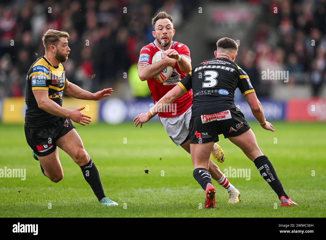 Ryan Brierley of Salford Red Devils is tackled by Jack Broadbent of Castleford Tigers the ...
