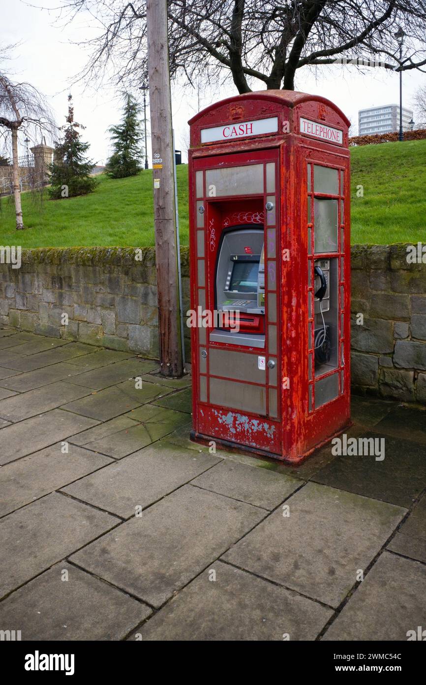Traditional phone kiosk repurposed as a cash machine and phone in the ...