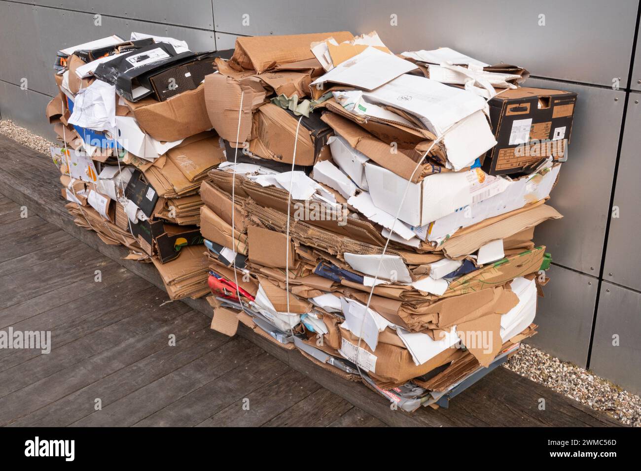 Cardboard waste tied together on a pallet Stock Photo - Alamy
