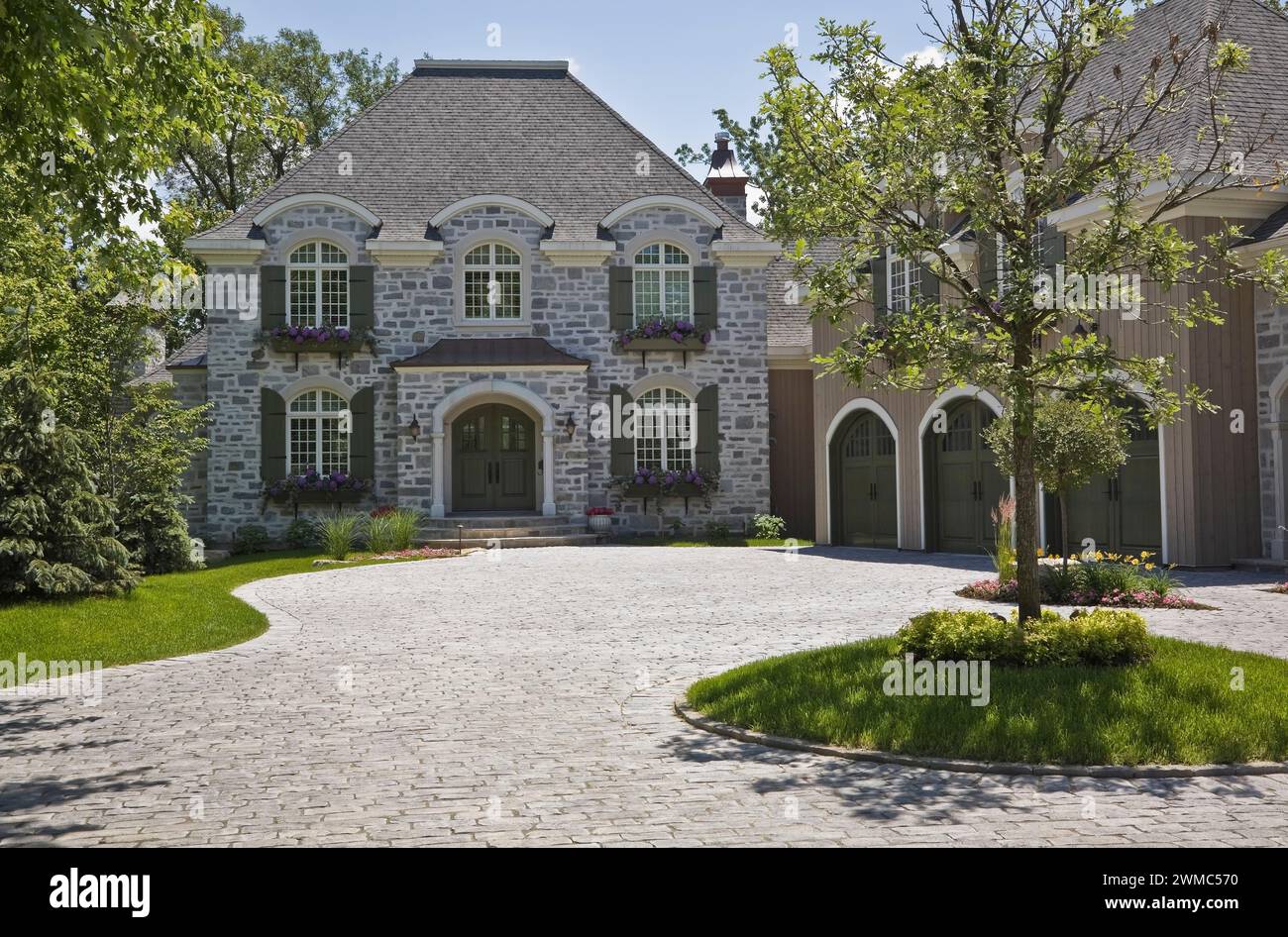 Large French Manor style natural stone home with three car garage and ...