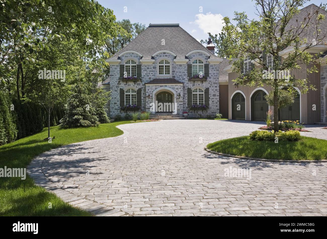 Large French Manor style natural stone home with three car garage and ...