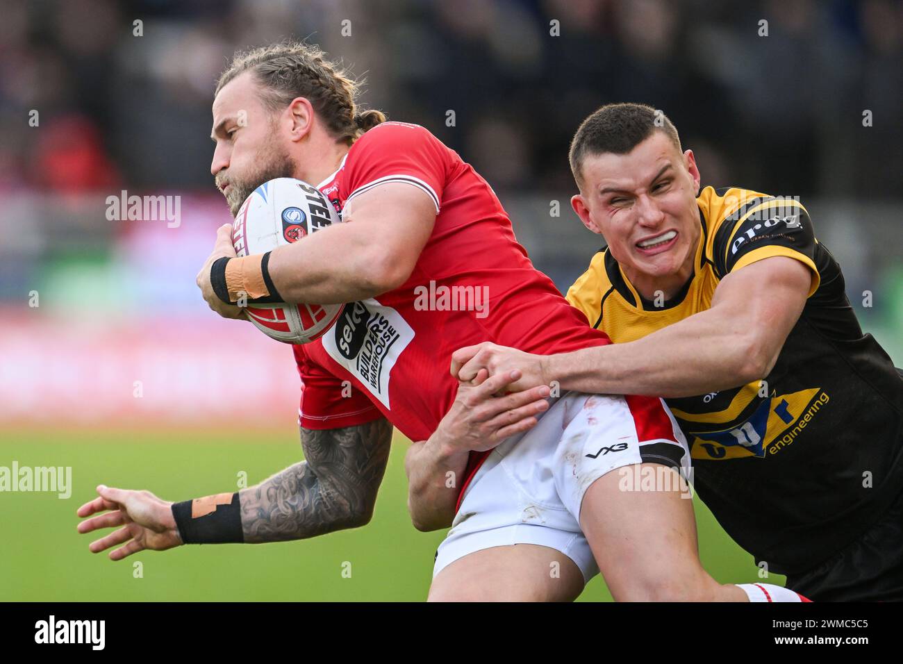 Chris Hankinson of Salford Red Devils is tackled by Innes Senior of Castleford Tigers during the ...