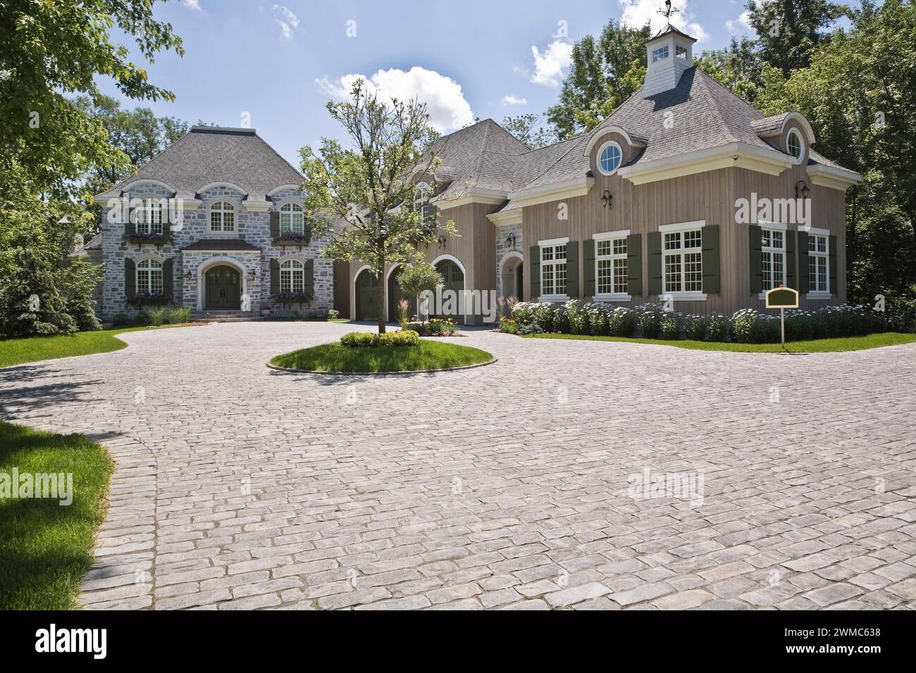 Large French Manor style natural stone home with three car garage and ...