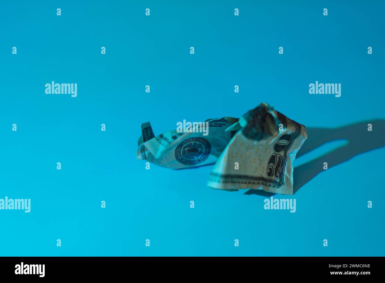 Damaged and marked twenty dollar bill on a blue background. High ...