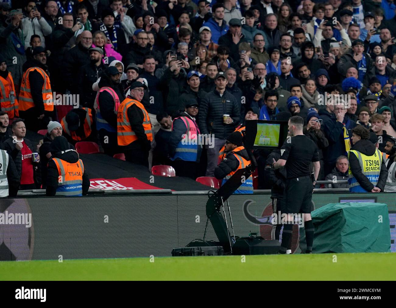 Referee Chris Kavanagh views the VAR pitch side monitor before ruling ...