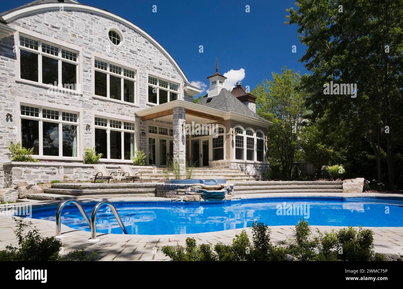 In-ground swimming pool in backyard of luxurious two story natural ...