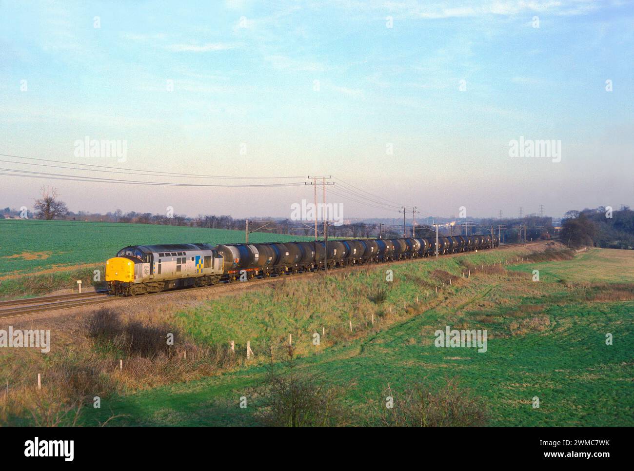 37679 working a lengthy train of four wheel oil tanks climbs Belsted ...