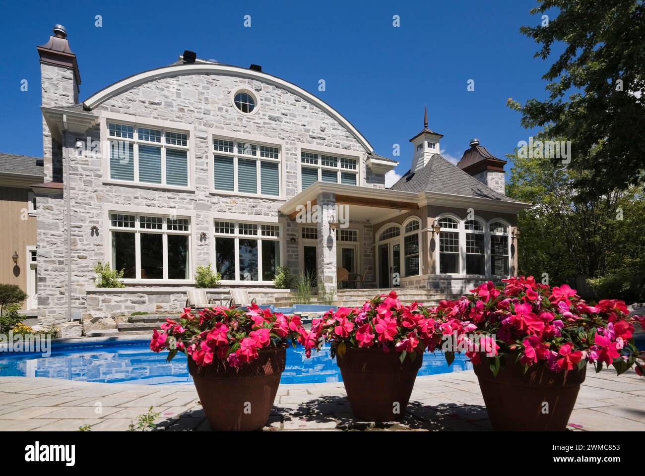 In-ground swimming pool in backyard of luxurious two story natural ...