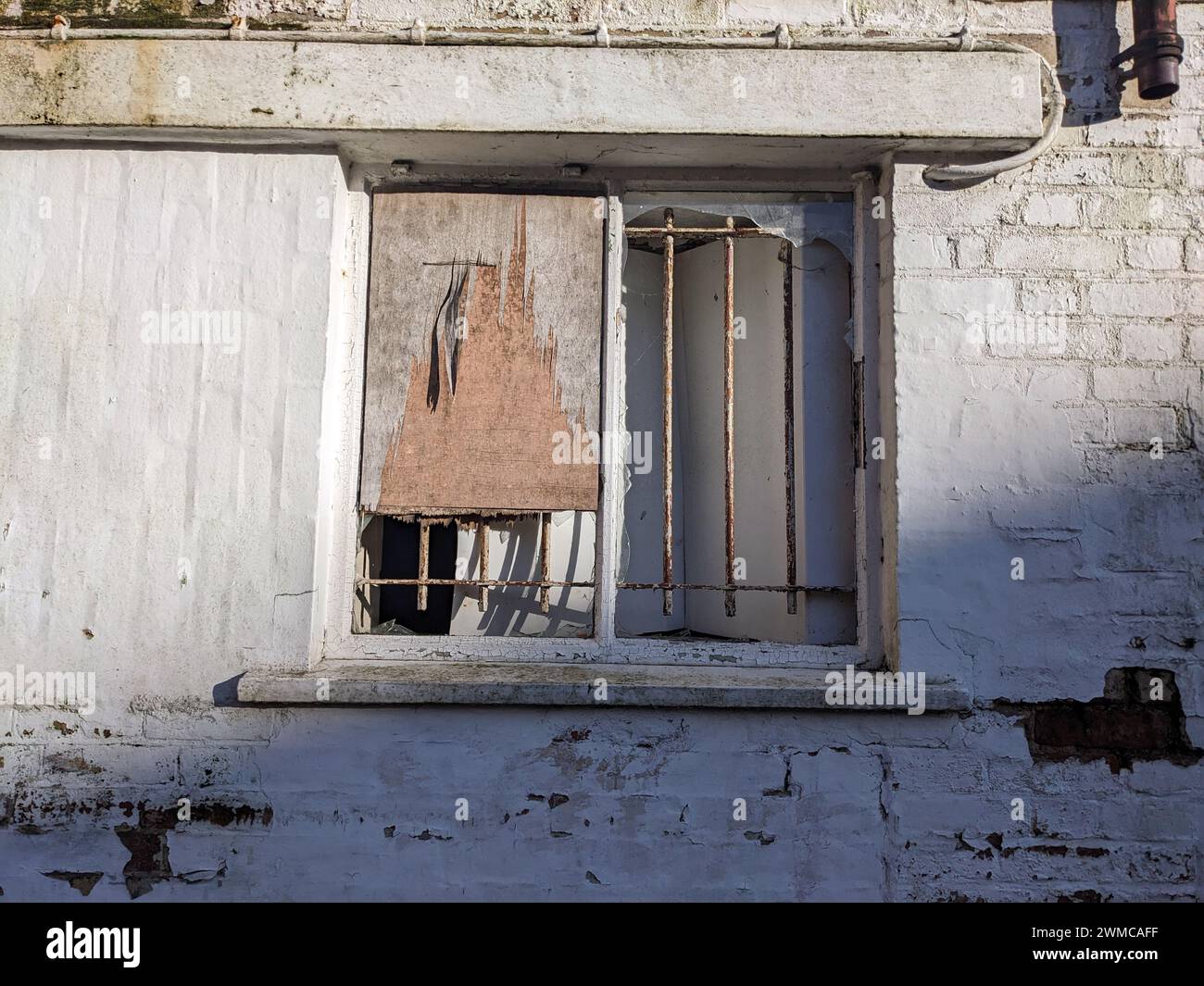 A Smashed Broken Window with Chipped Wall Down an AlleyWay Abandoned Building Stock Photo - Alamy