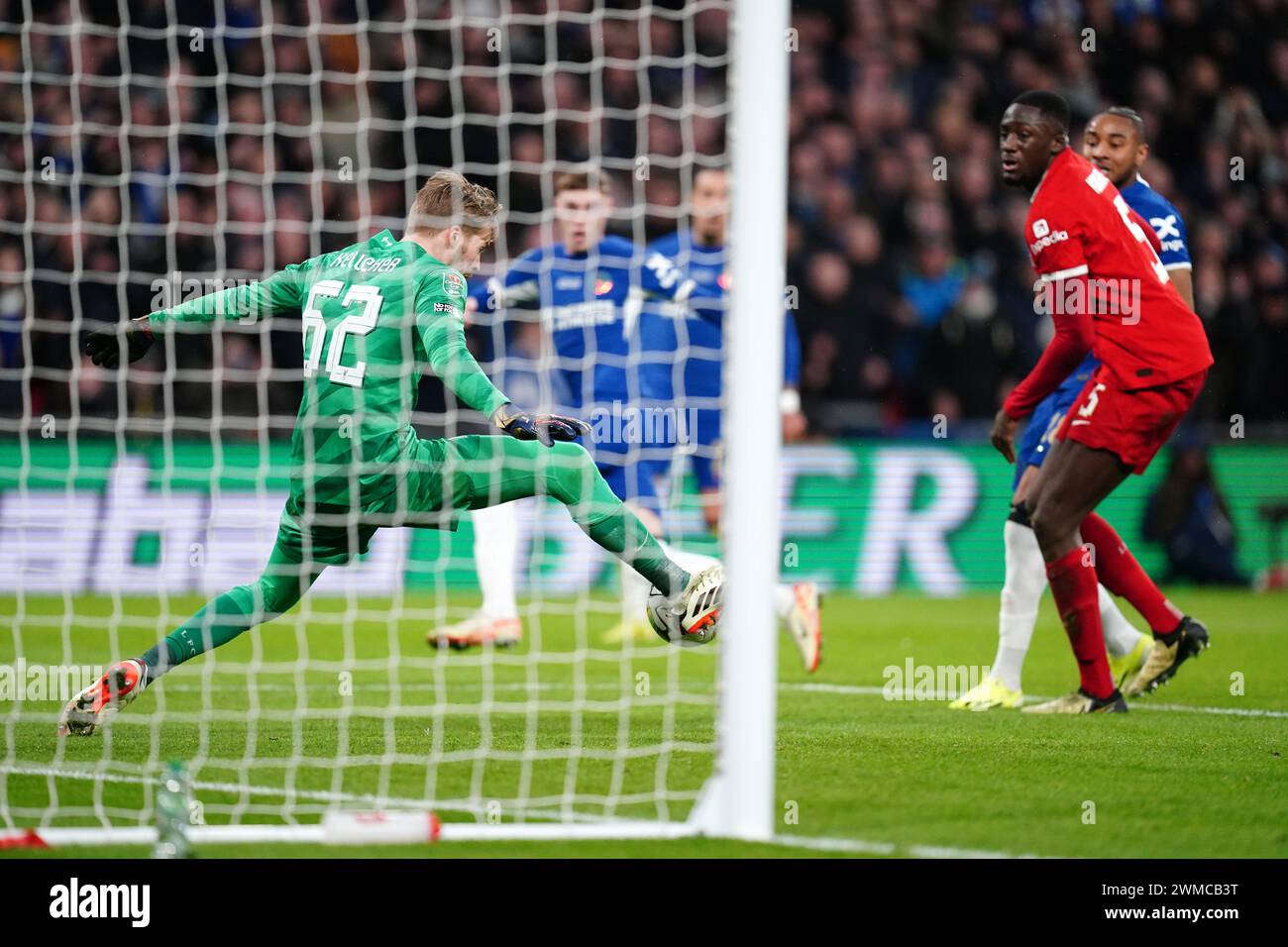 Liverpool goalkeeper Caoimhin Kelleher saves from Chelsea's Cole Palmer ...