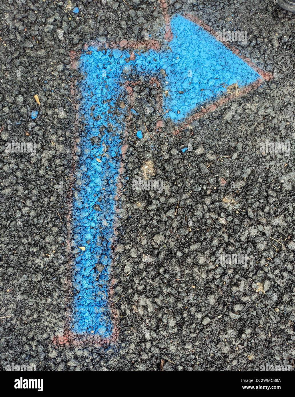 A Blue Arrow Painted on Pavement Pointing Stock Photo - Alamy