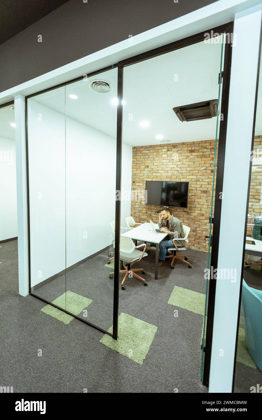 Person is immersed in a task in a stylish office with transparent glass ...