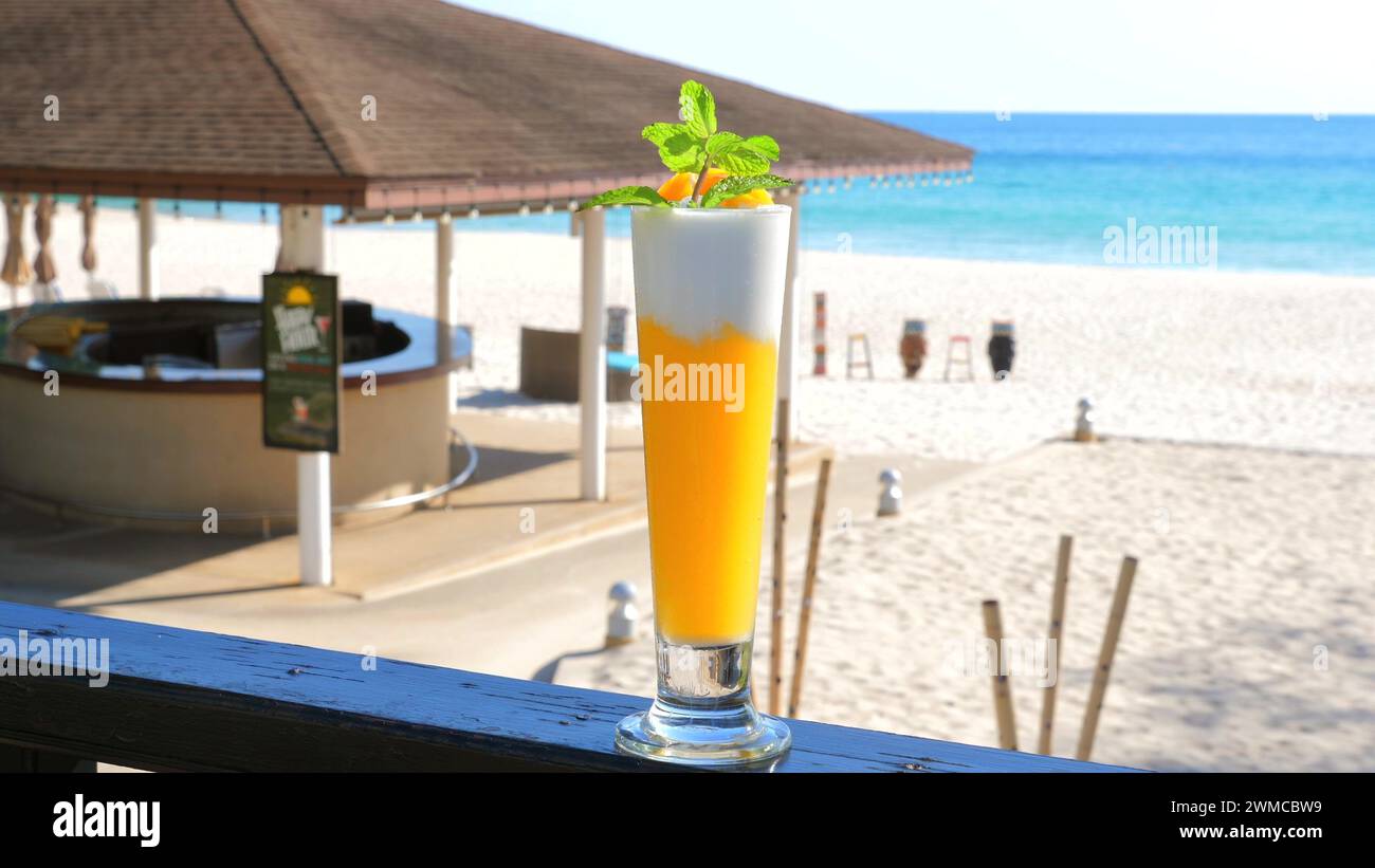 Refreshing tropical cocktail on beachside bar counter with pristine ...