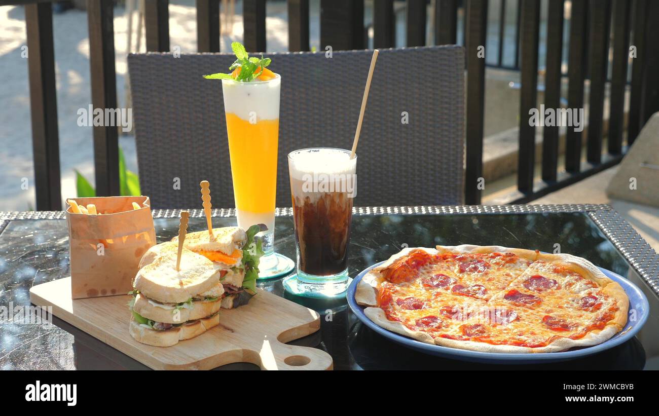Al fresco dining setup featuring refreshing cocktail, gourmet sandwich ...