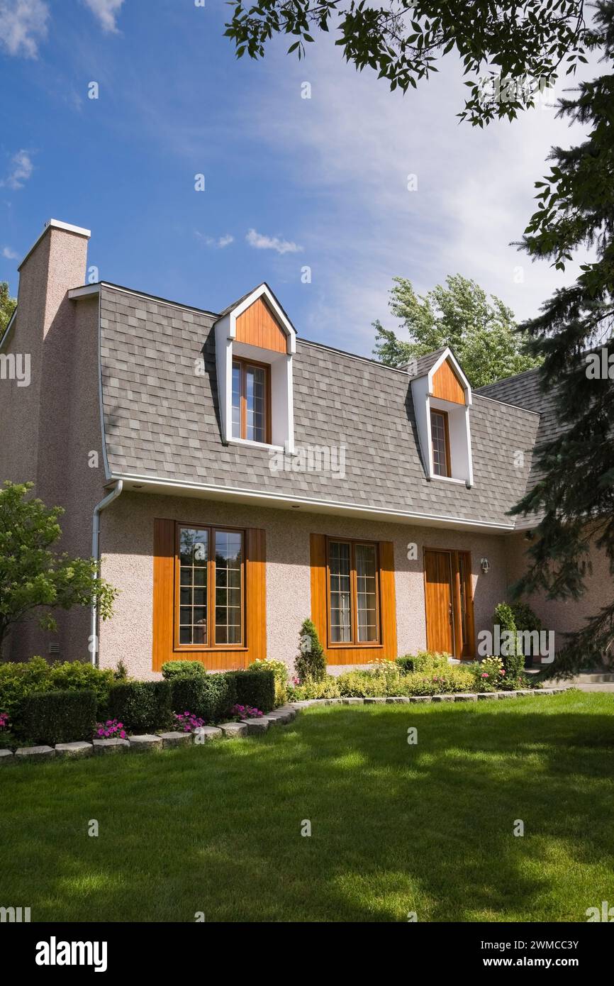 Modern two storied tan stucco Canadiana style home with mansard style ...