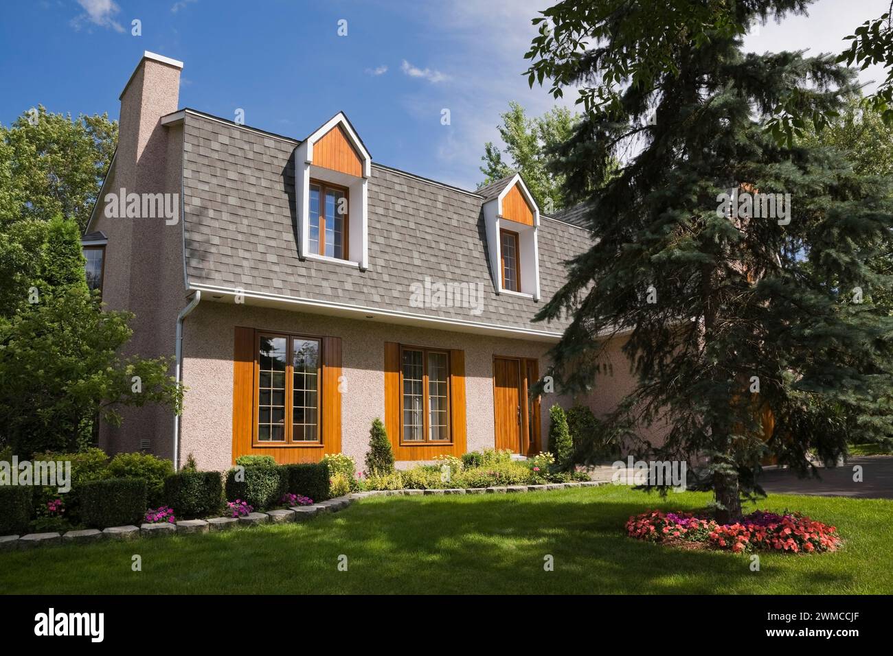 Modern two storied tan stucco Canadiana style home with mansard style ...