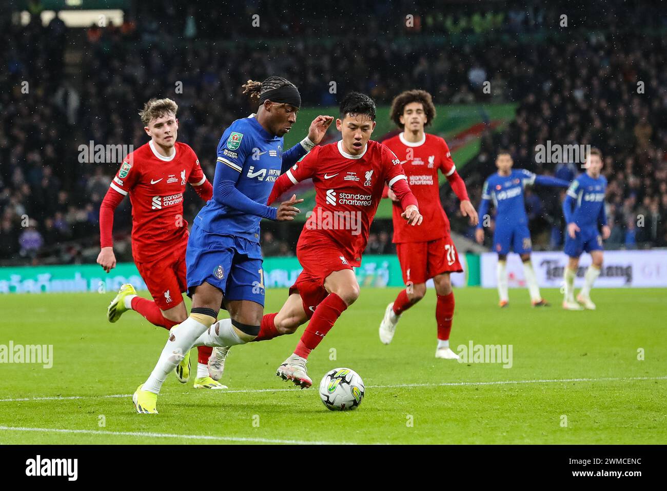 Noni Madueke of Chelsea breaks with the ball tracked by Wataru Endo of ...