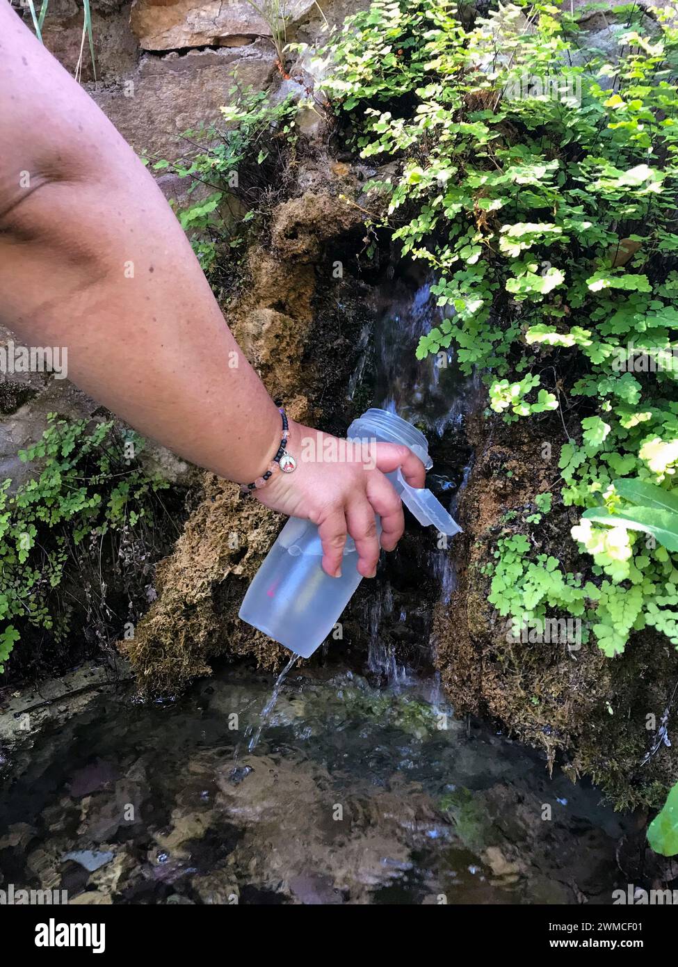 Filling water bottle by stream hi-res stock photography and images - Alamy
