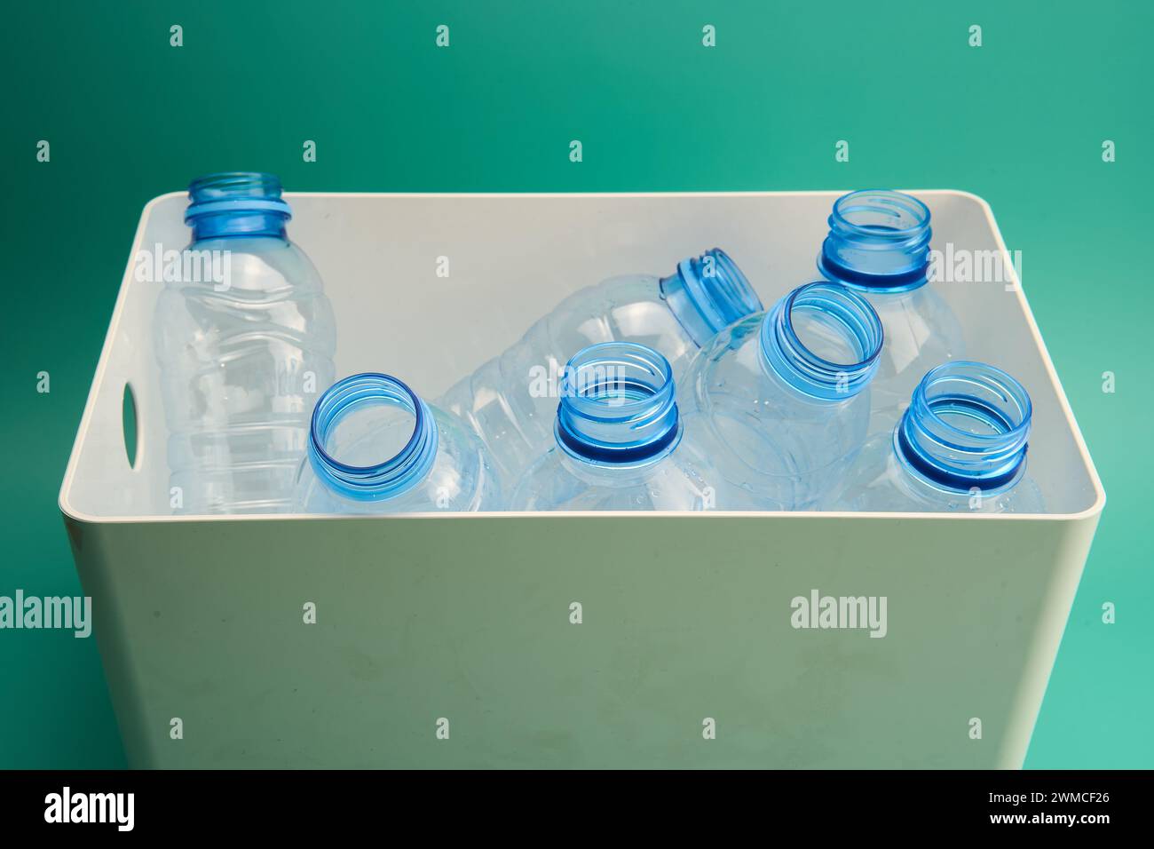 From above of recycled open empty plastic bottles in white box placed ...