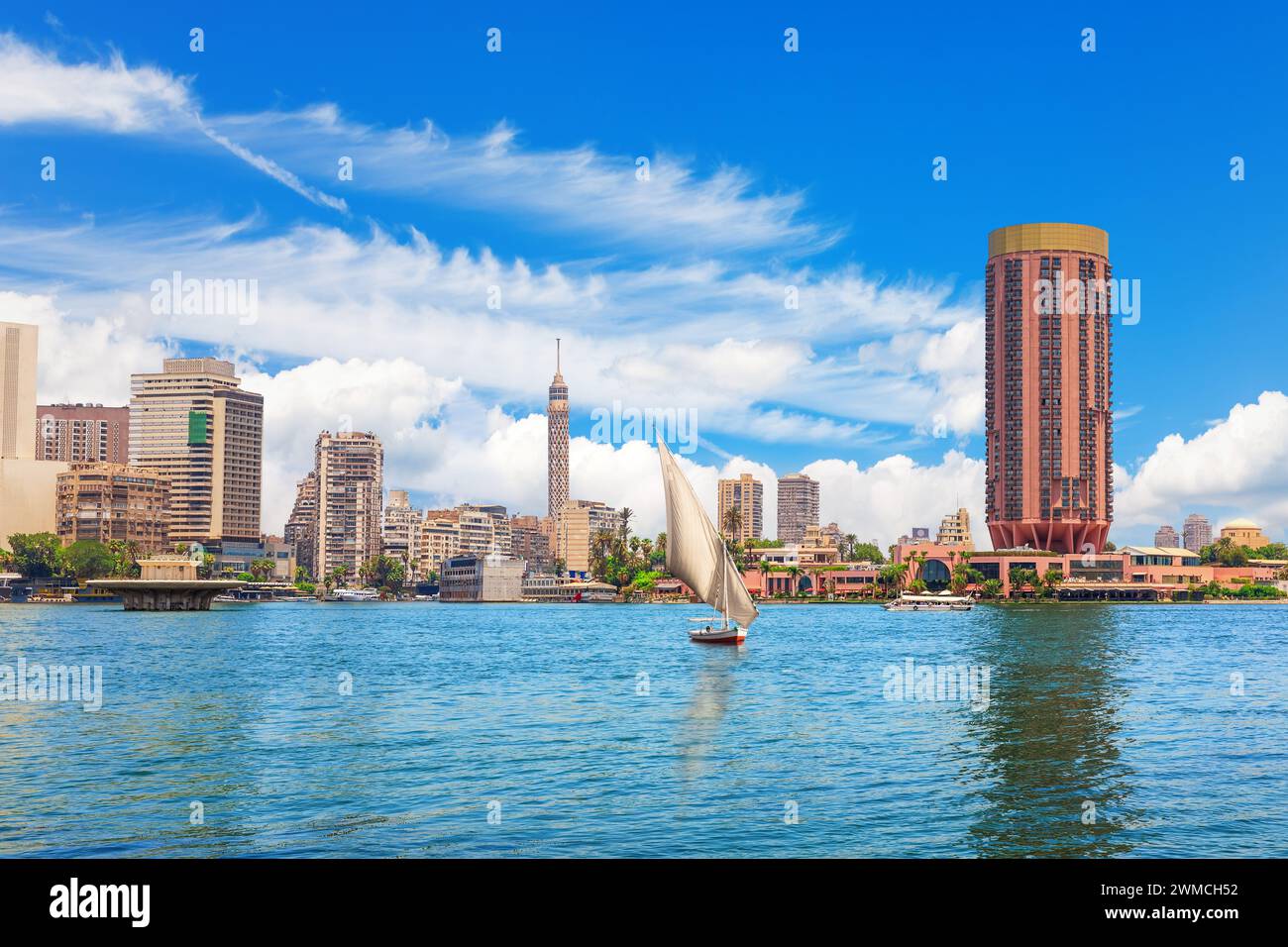 Typical sailboat in the Nile river and fancy buildings of Cairo, Egypt ...