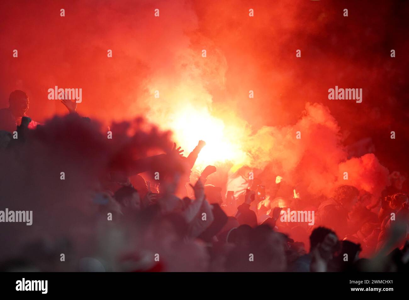 Liverpool fans let off a smoke flare as they celebrate in the stands ...