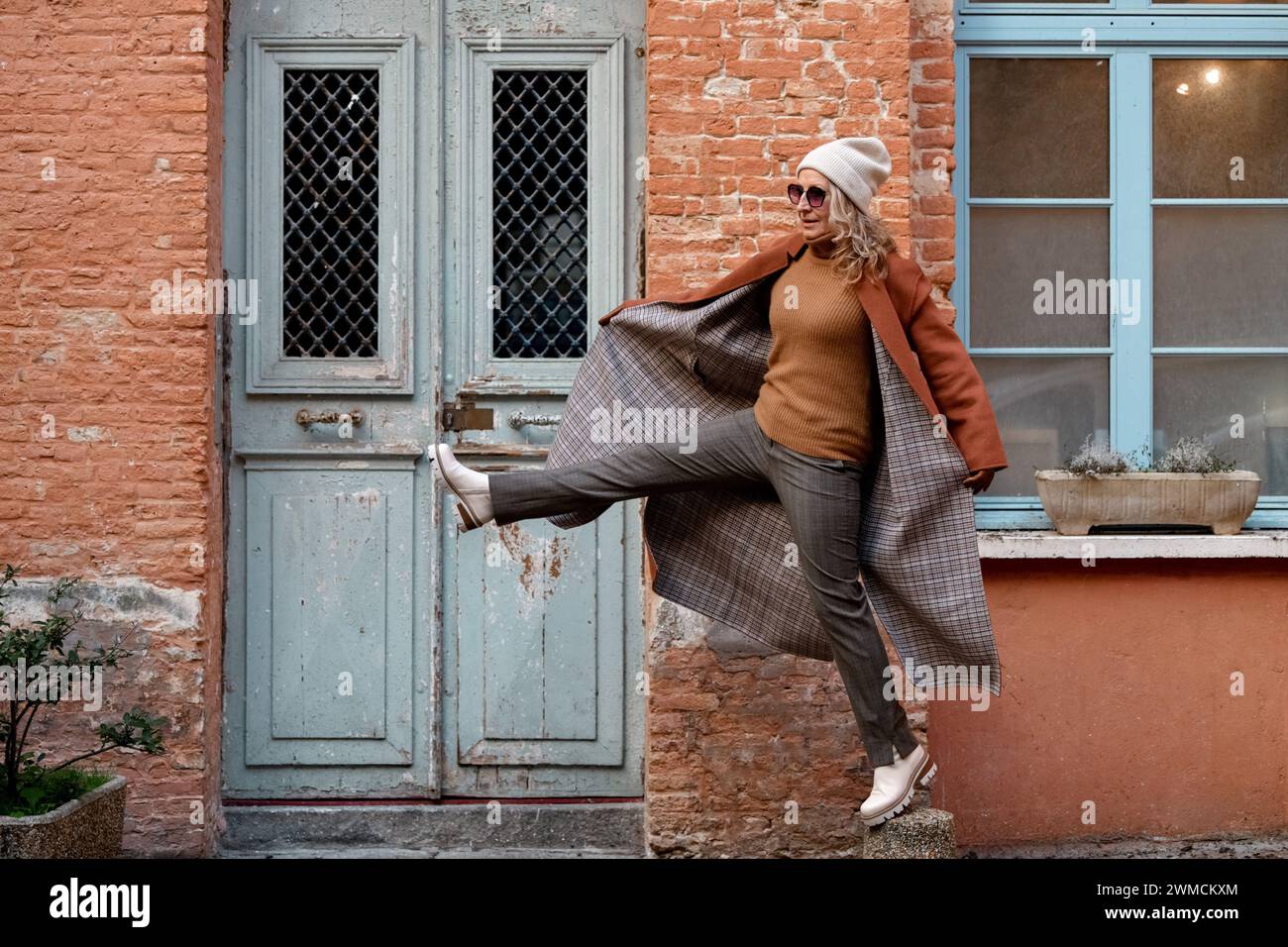 A woman in terracotta coat and leather gloves in the city Stock Photo ...