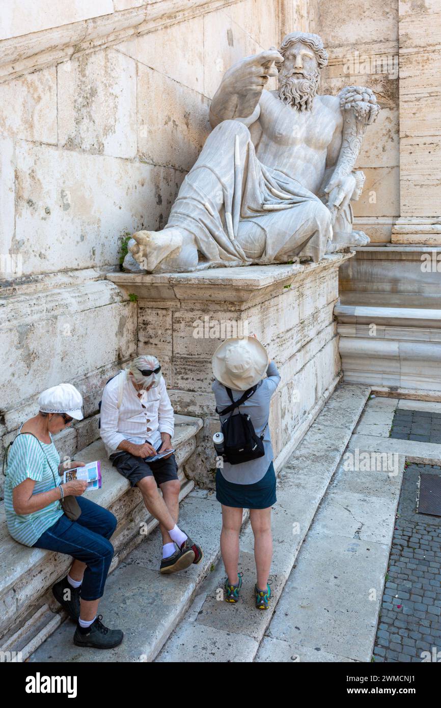 Tourists in Rome admire the Roman statue of the divinity of the Nile ...