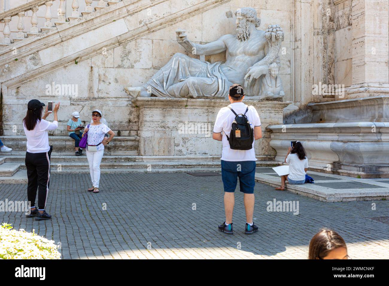 Tourists in Rome admire the Roman statue of the divinity of the Nile ...