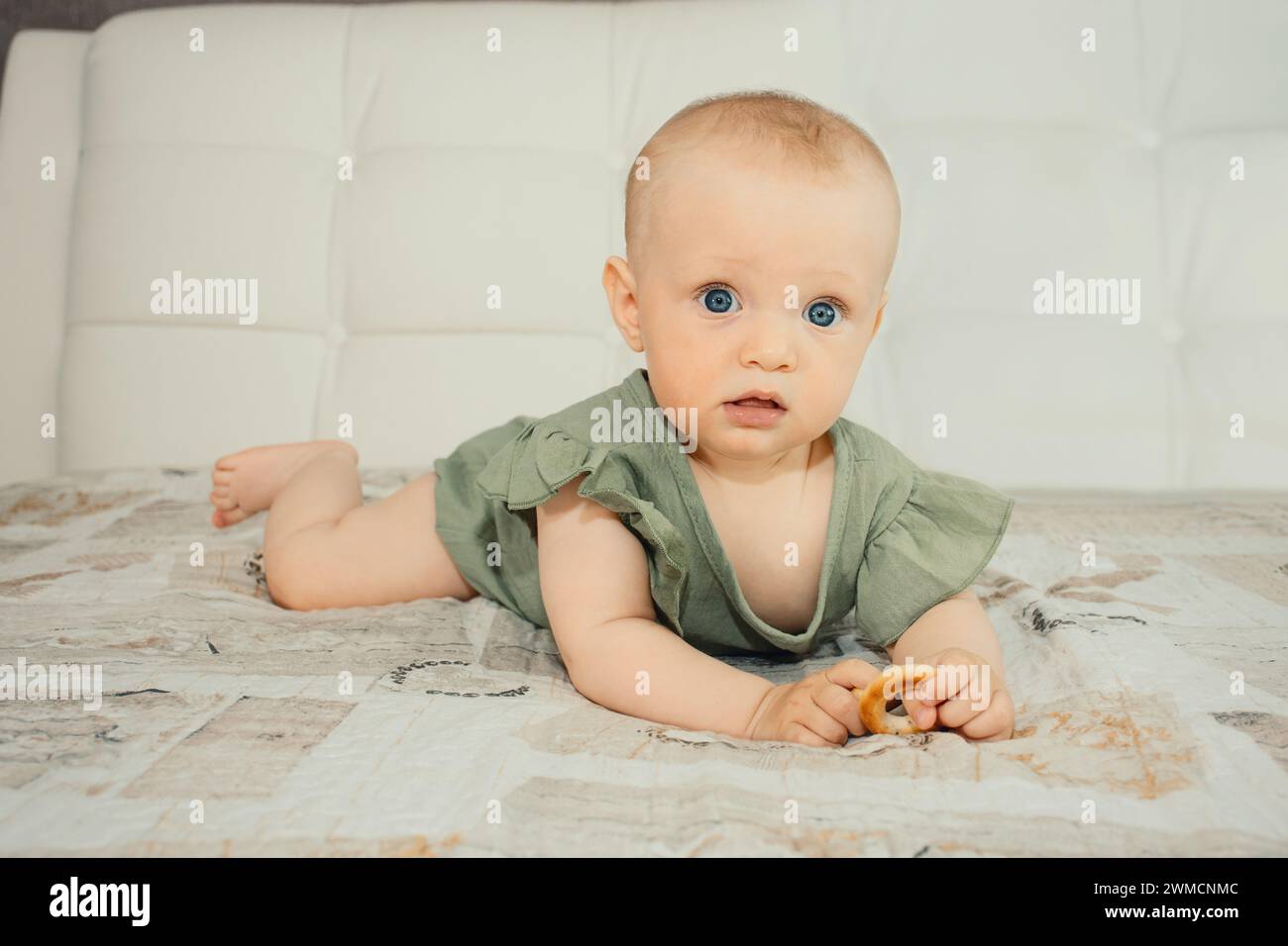 small happy kid in green looking forward seriously Stock Photo - Alamy