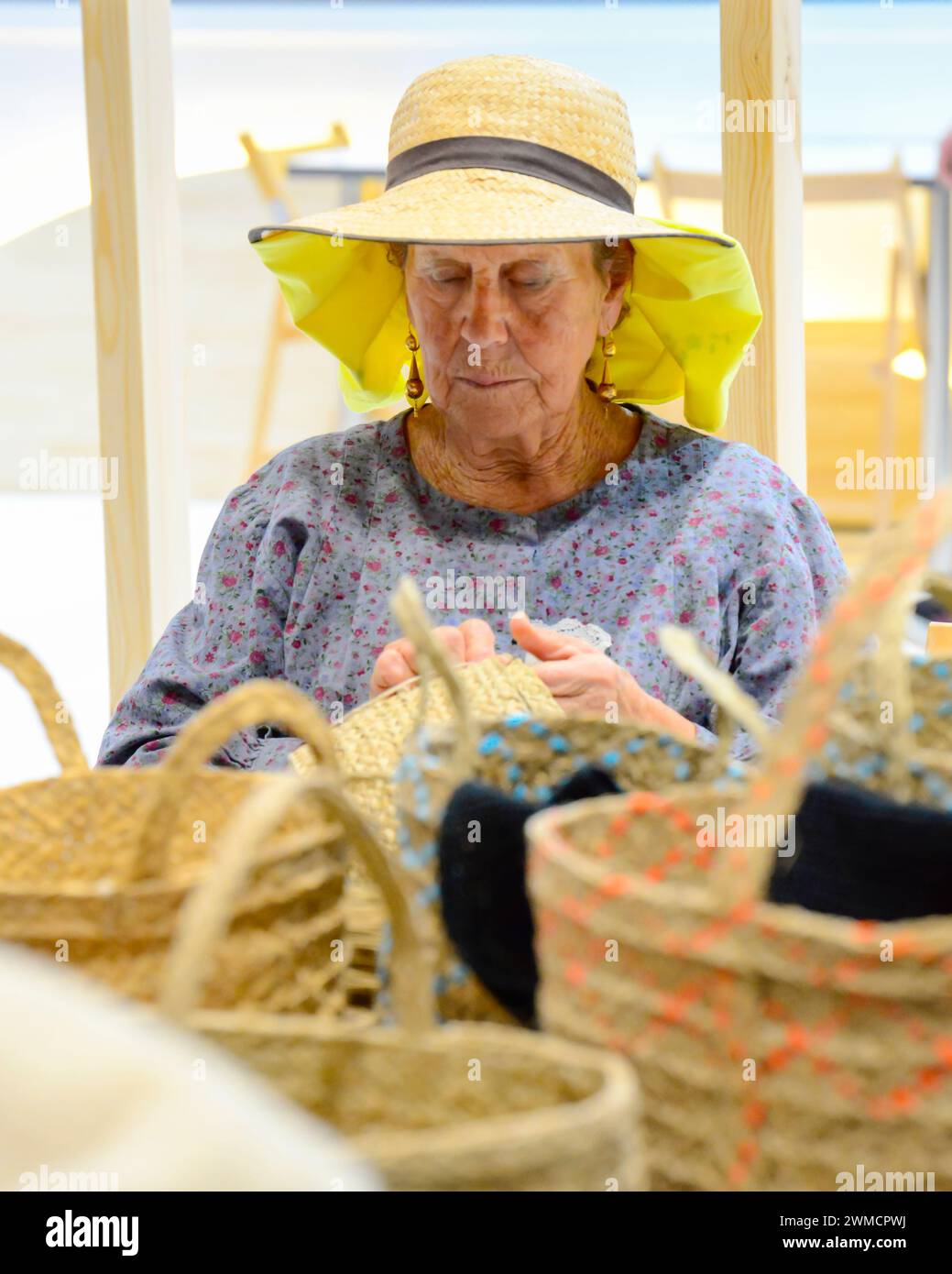 A portrait of a woman basket weaving showing skills in handicrafts from ...