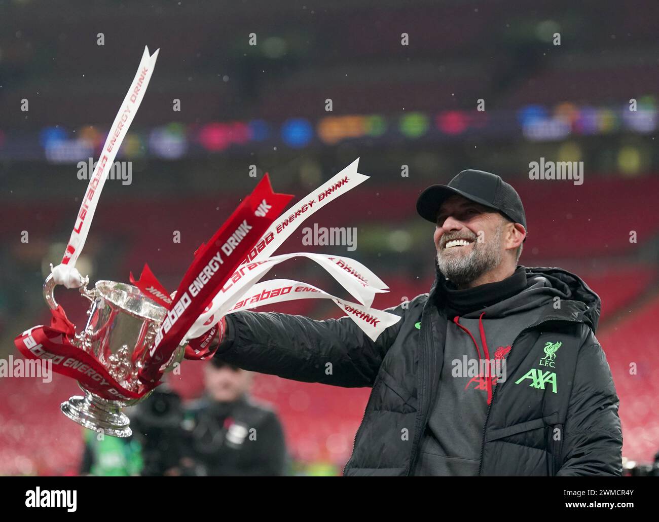 Liverpool manager Jurgen Klopp lifts the trophy after the Carabao Cup ...