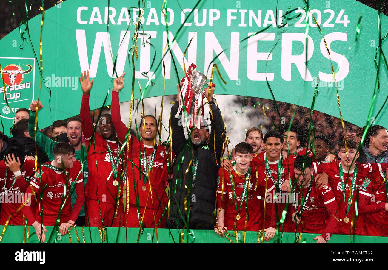 Liverpool manager Jurgen Klopp lifts the trophy after winning the ...