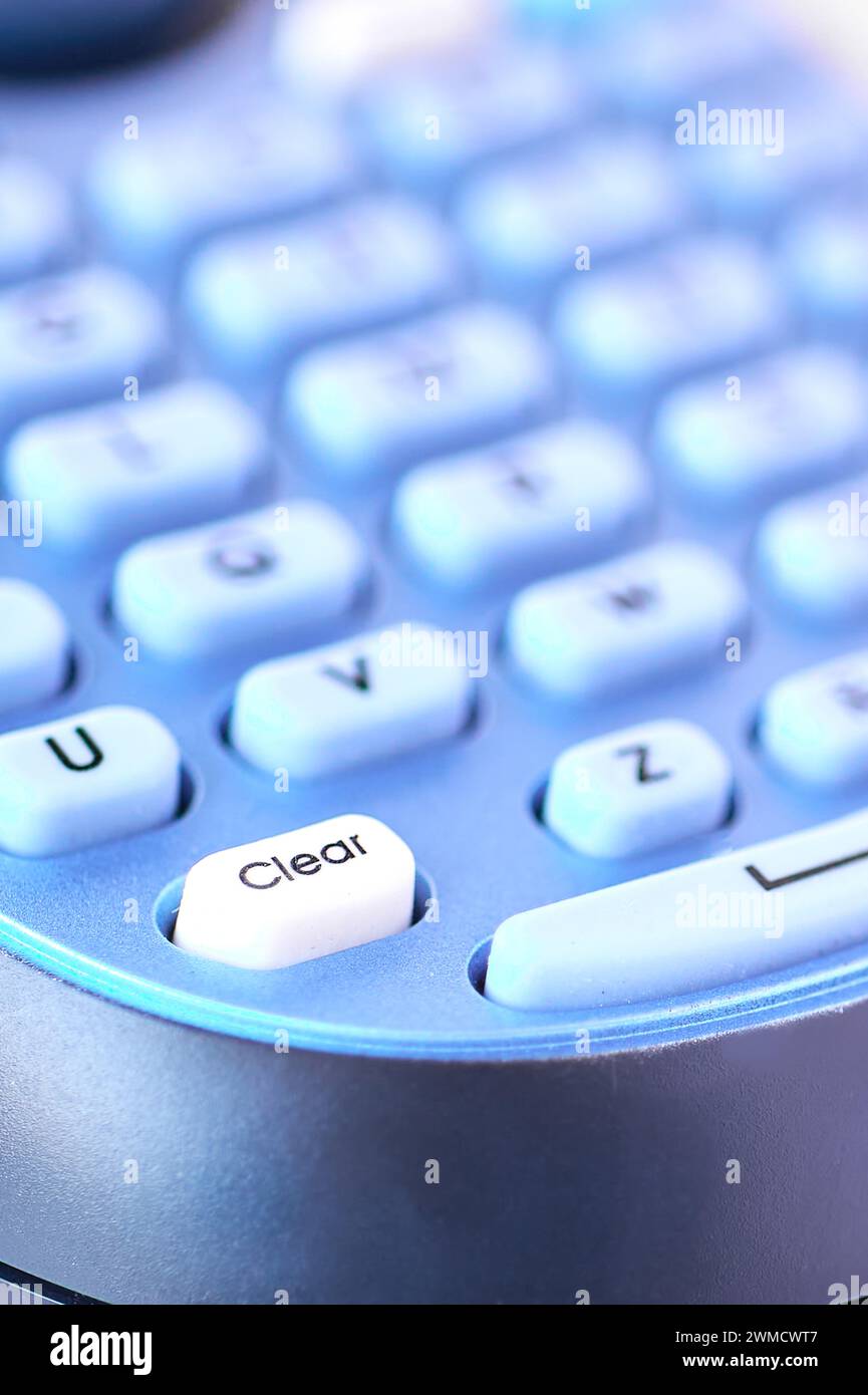 Macro image of a white 'Clear' button on a blue keyboard, ideal for ...