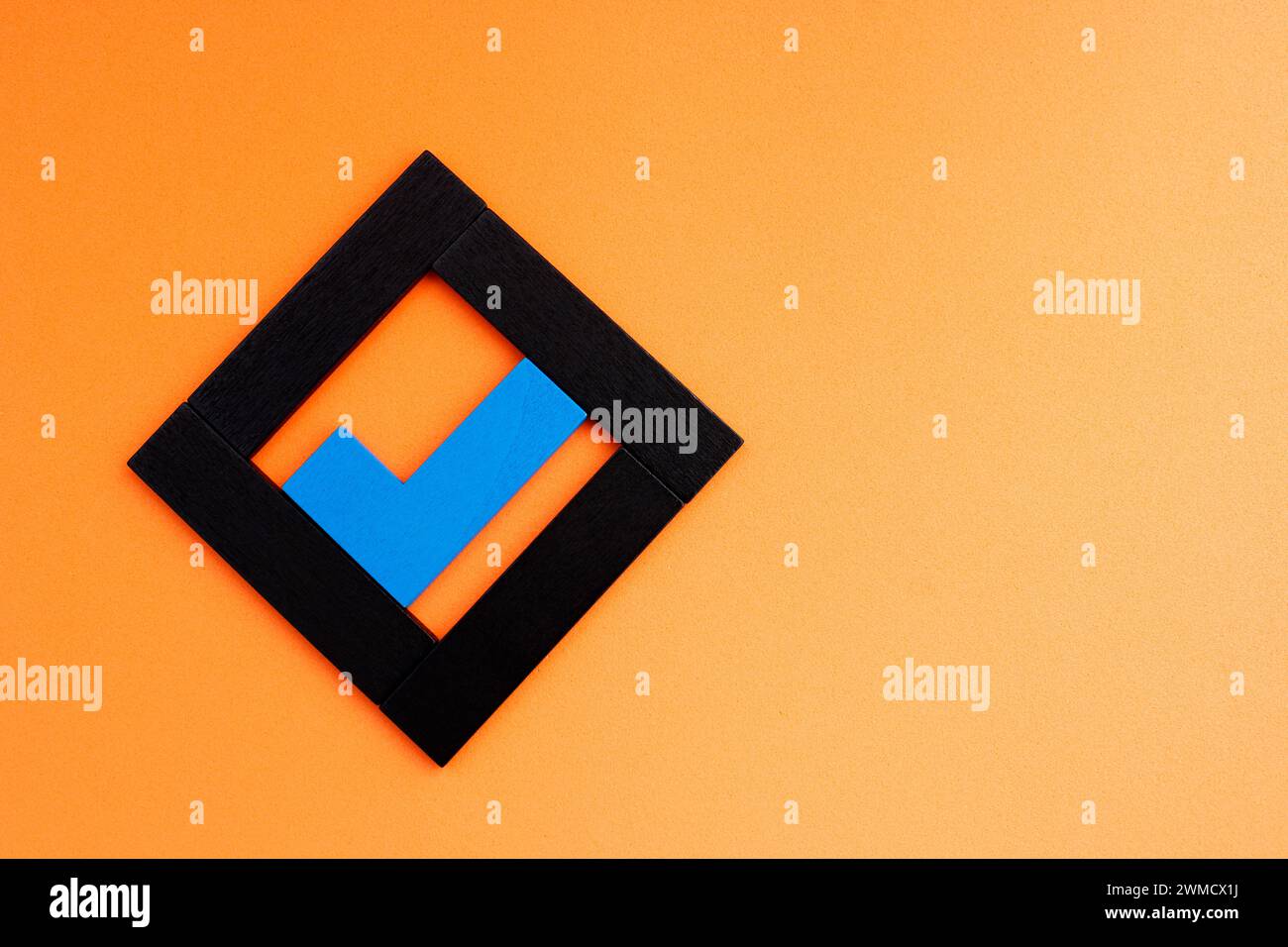 Check mark inside box, wooden figures Stock Photo - Alamy