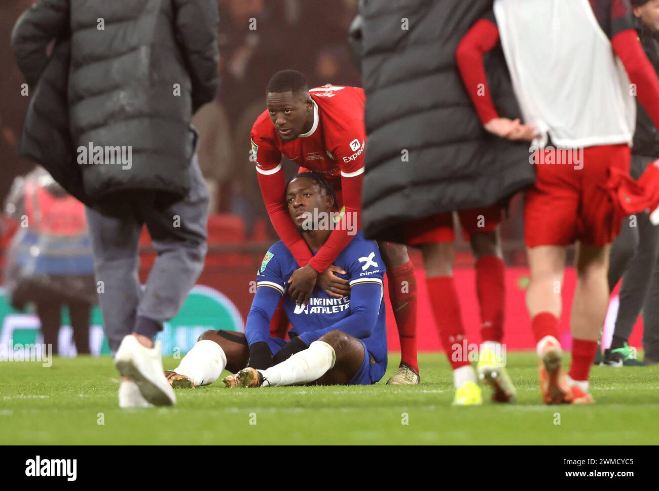 London, UK. 25th Feb, 2024. Ibrahima Konate (L) consoles Axel Disasi (C ...