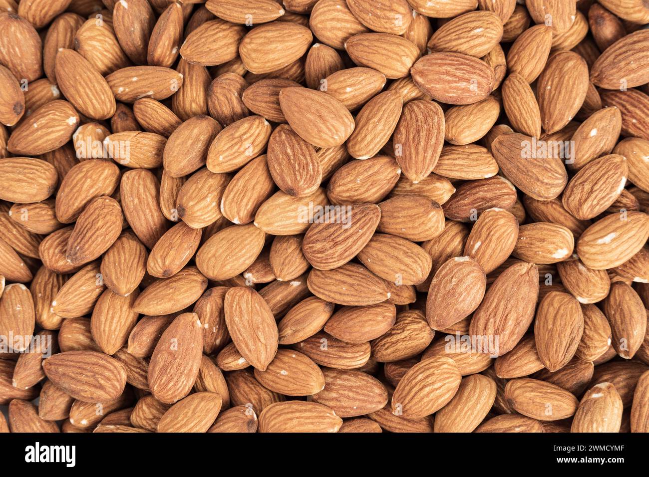 Close up with many fresh organic peeled almonds . Natural texture ...