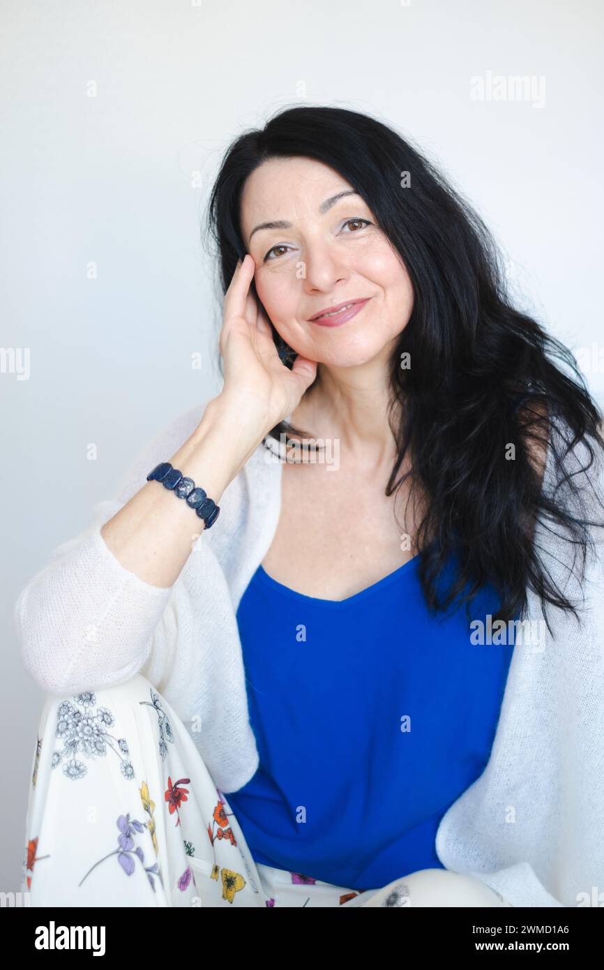 Smiling woman with black hair, blue top, in her late 40s. for midlife ...