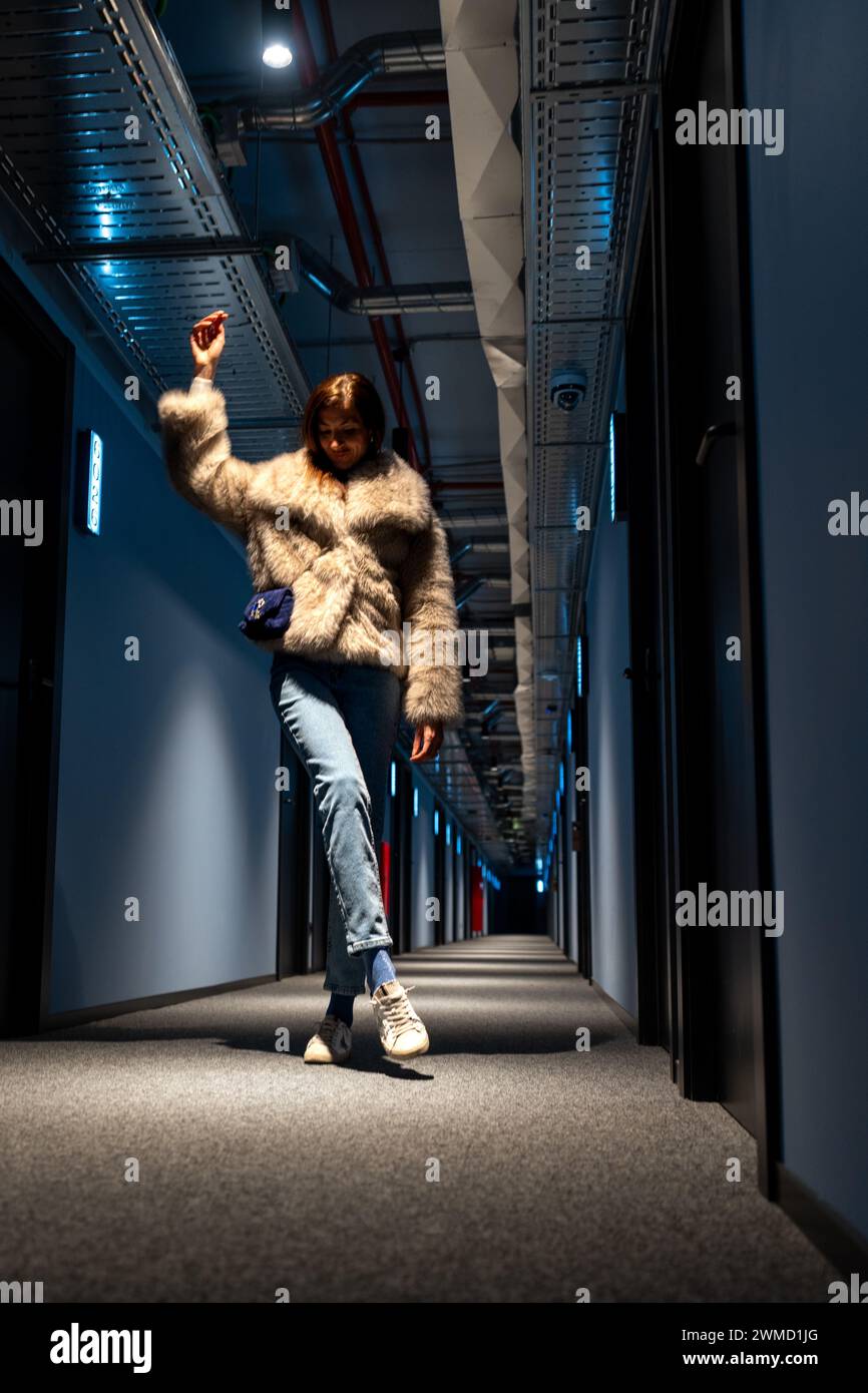 Model with jeans and fur coat in hotel hallway, Spain Stock Photo - Alamy