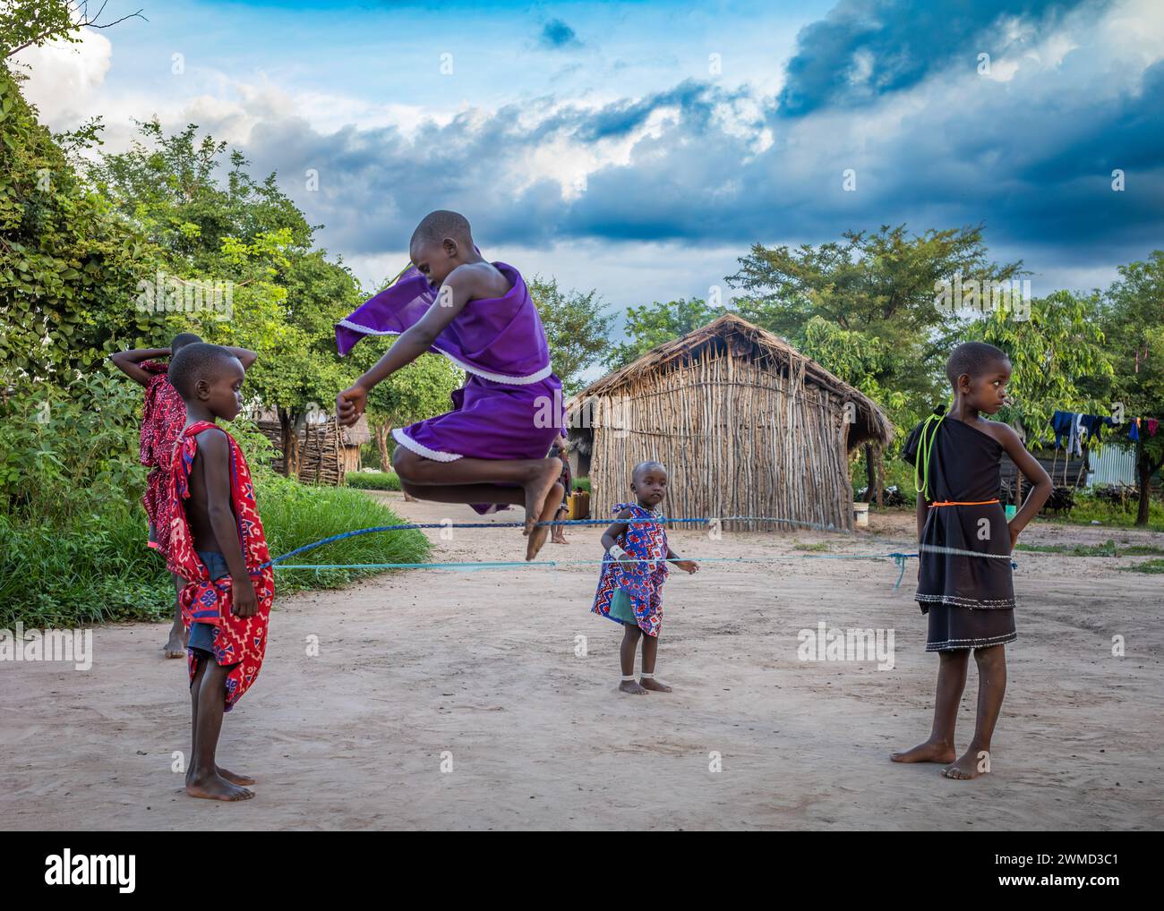 Young Maasai children play a skipping and jumping game in their ...