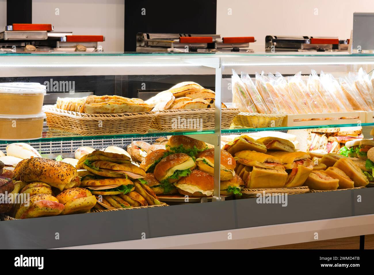 Delicious sandwiches and filled rolls on sale in the display case of ...