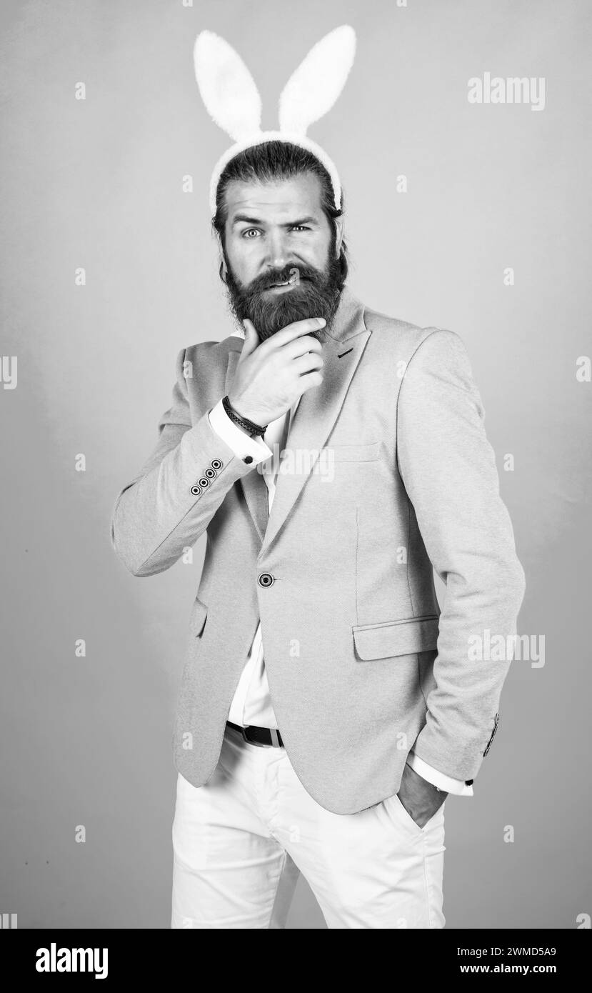 mature bearded male guy looking elegant wearing bunny ears, easter ...