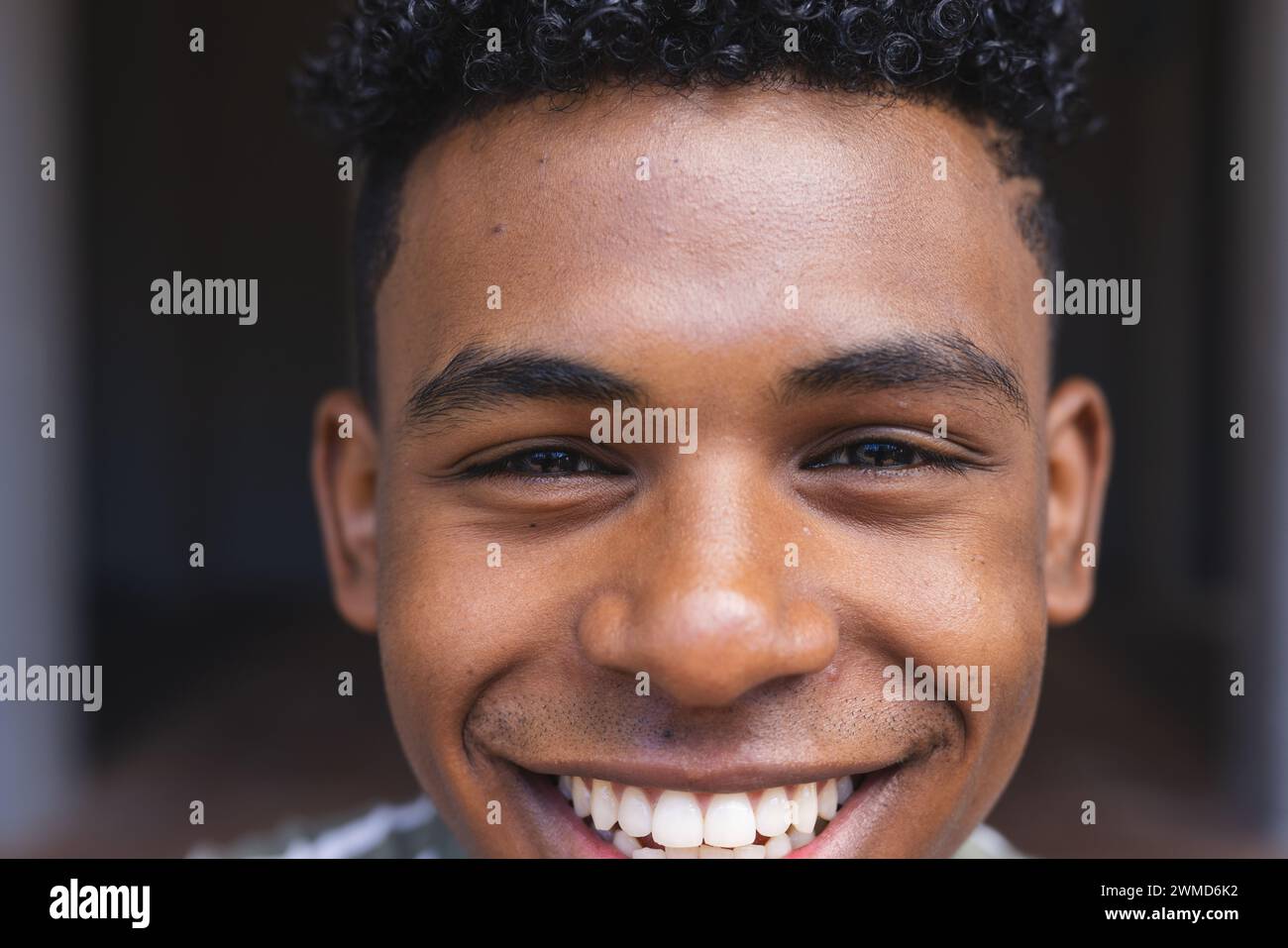 A teenage biracial boy smiles brightly Stock Photo - Alamy