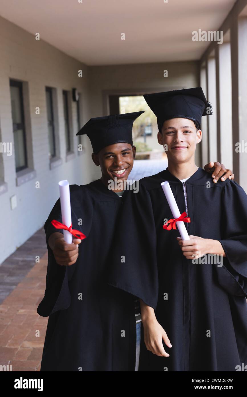 Two teenage biracial boys celebrate graduation outdoors Stock Photo - Alamy