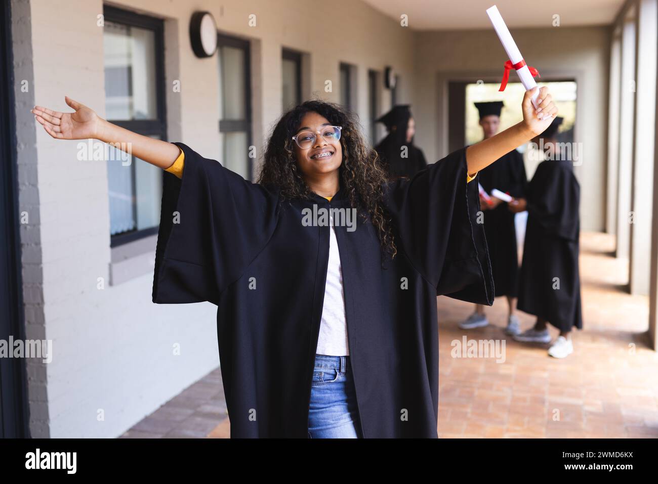 Graduating student celebrates her achievement outdoors Stock Photo - Alamy