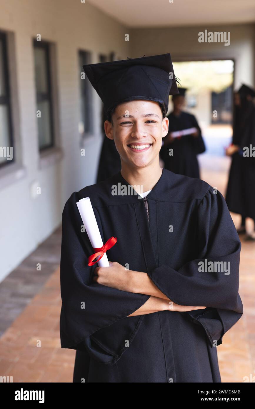 Proud teenage biracial boy in graduation attire Stock Photo - Alamy