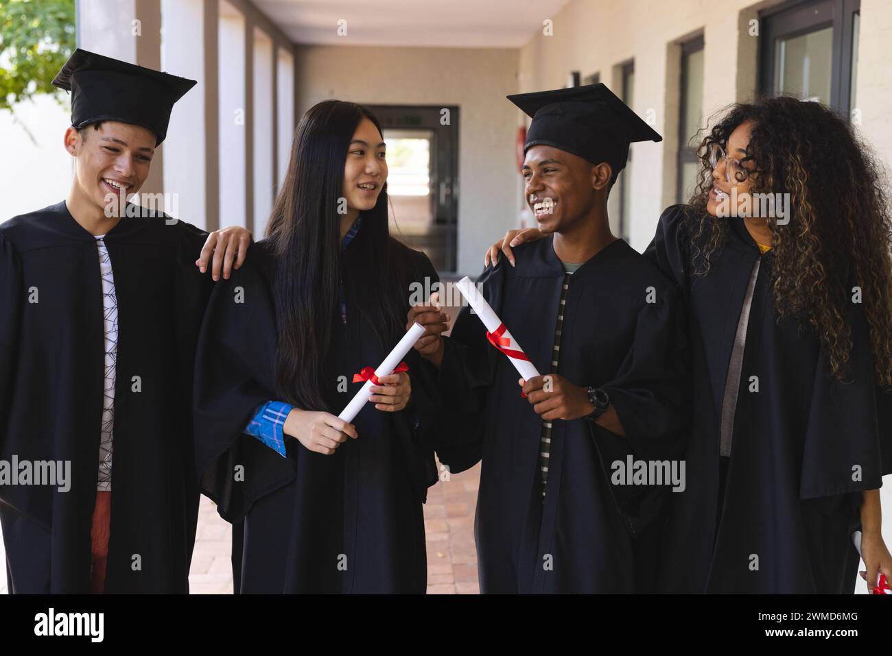 Diverse students celebrate graduation at high school Stock Photo - Alamy