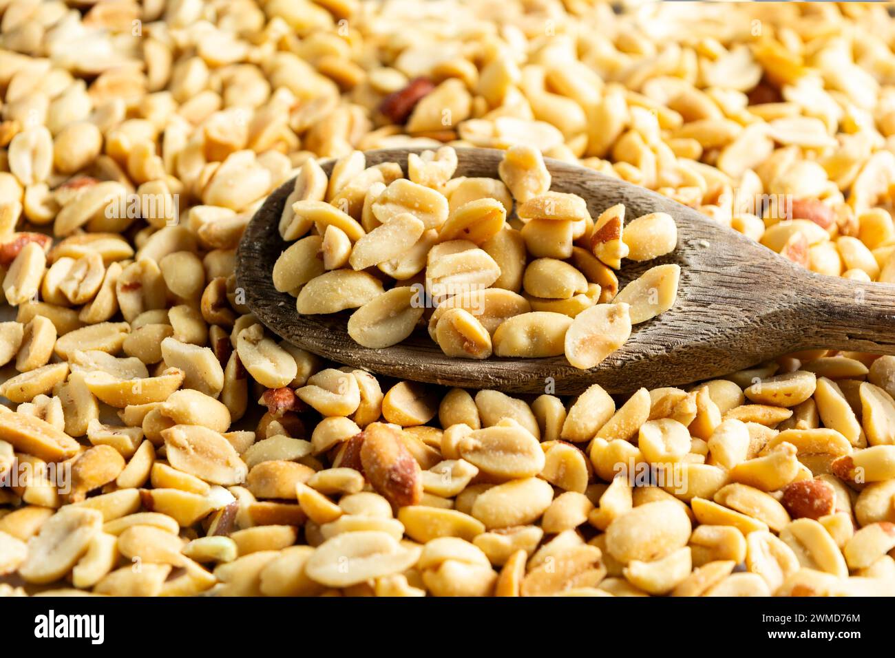 Roasted shelled peanuts in a container with wooden spoon Stock Photo ...