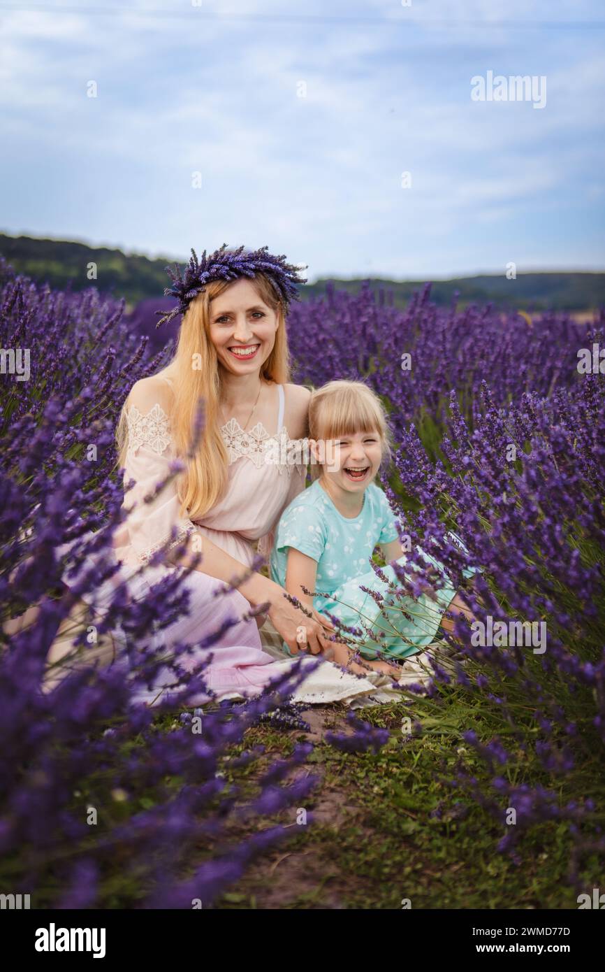 mom hugs her daughter. family picnic on a lavender field Stock Photo - Alamy