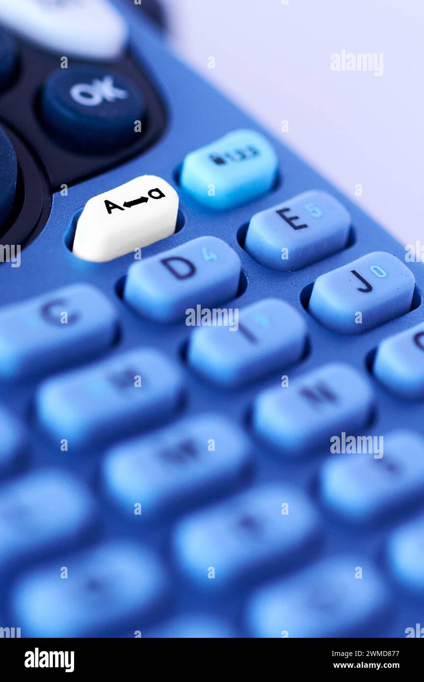 Macro image of a modern keyboard, highlighting blue buttons and a white ...